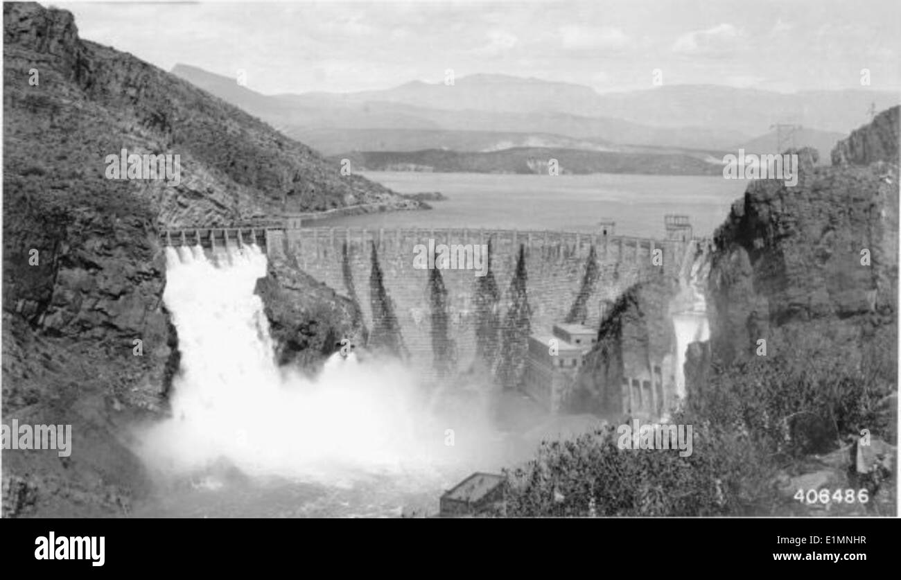 This black and white photograph captures a historic dam in the ...