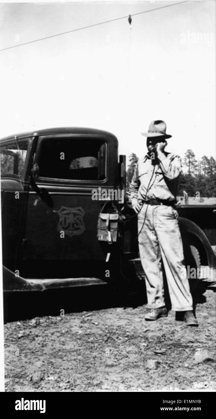 A historic black-and-white photograph showcasing a forest ranger from ...