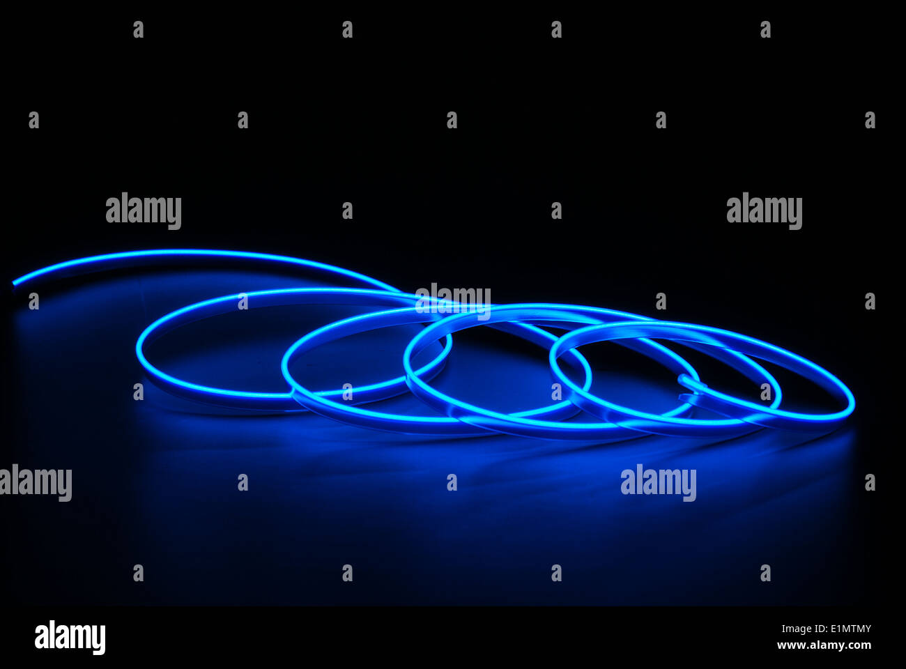 Blue neon stripe is isolated on the black background Stock Photo - Alamy