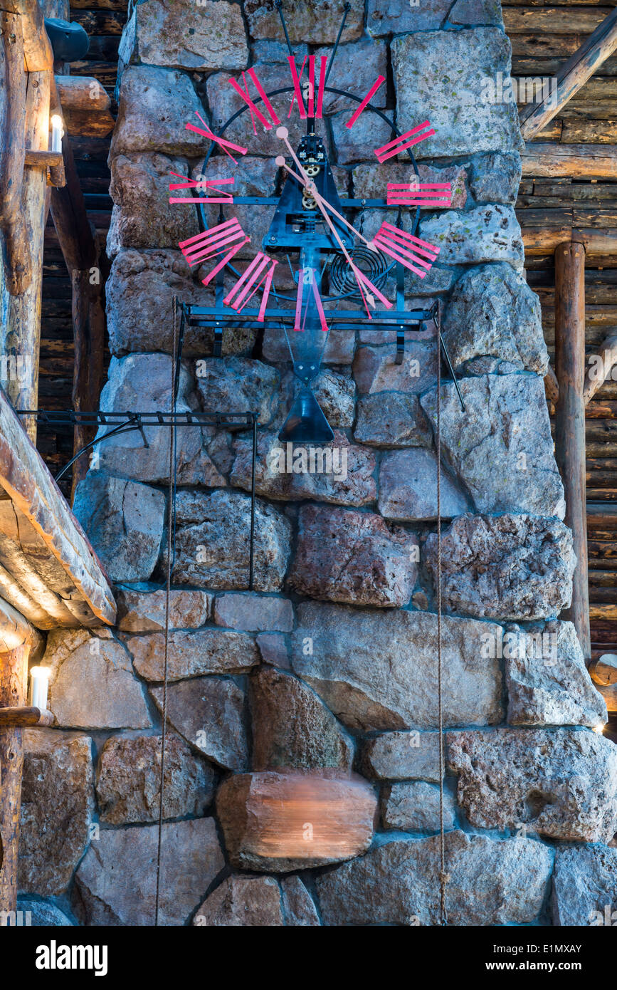 The giant clock in front of the stone fireplace inside Old Faithful Inn ...