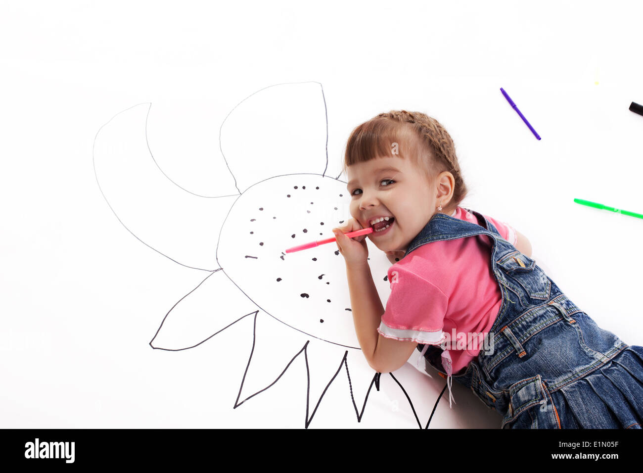 Happy little girl drawing Stock Photo - Alamy