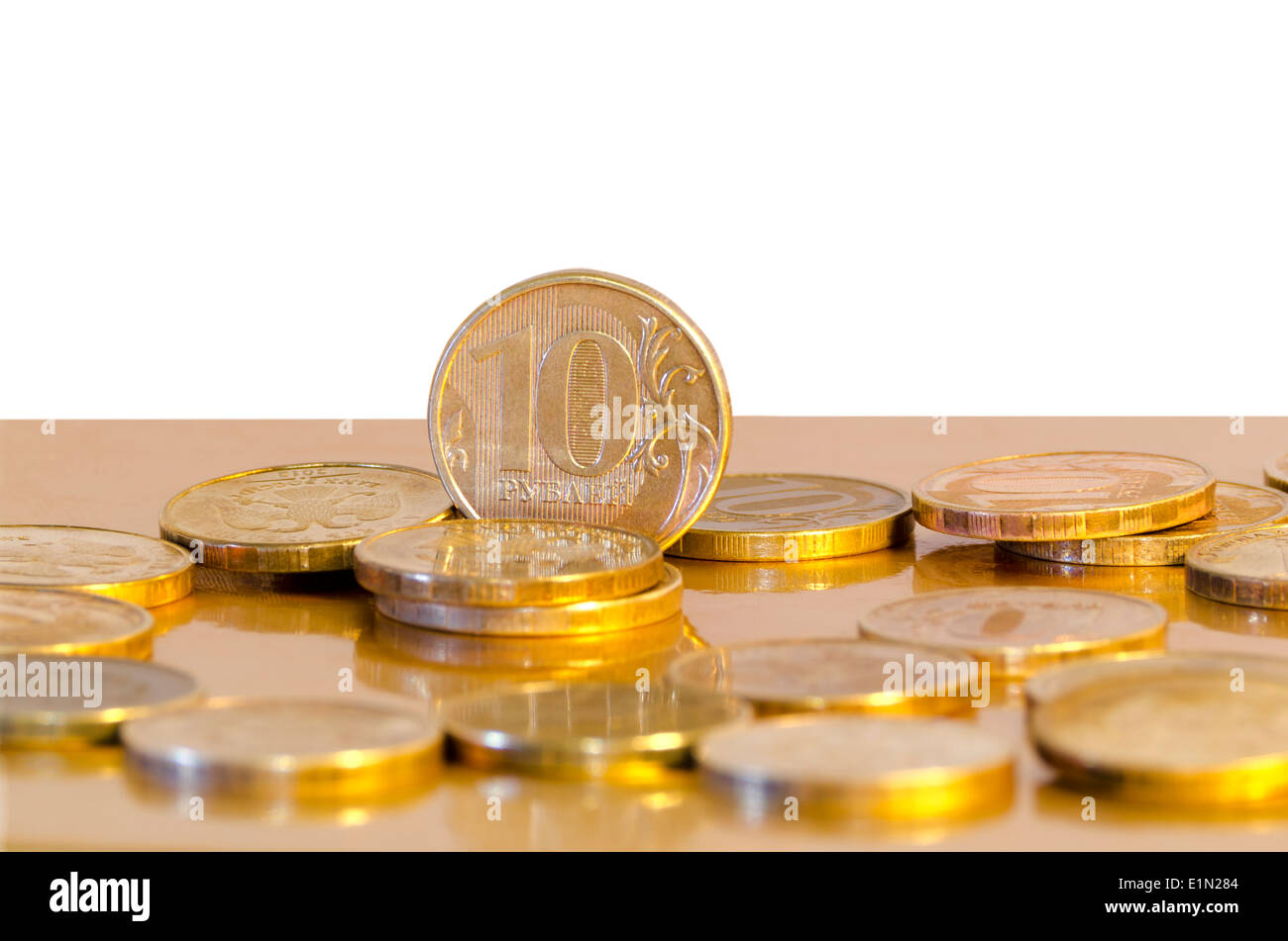 Ten-rouble coins on Golden surface with white background Stock Photo ...