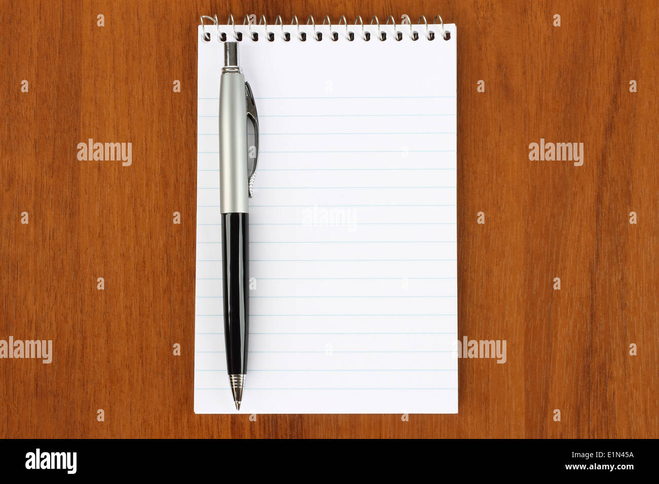 Notepad and pen on wooden background Stock Photo - Alamy