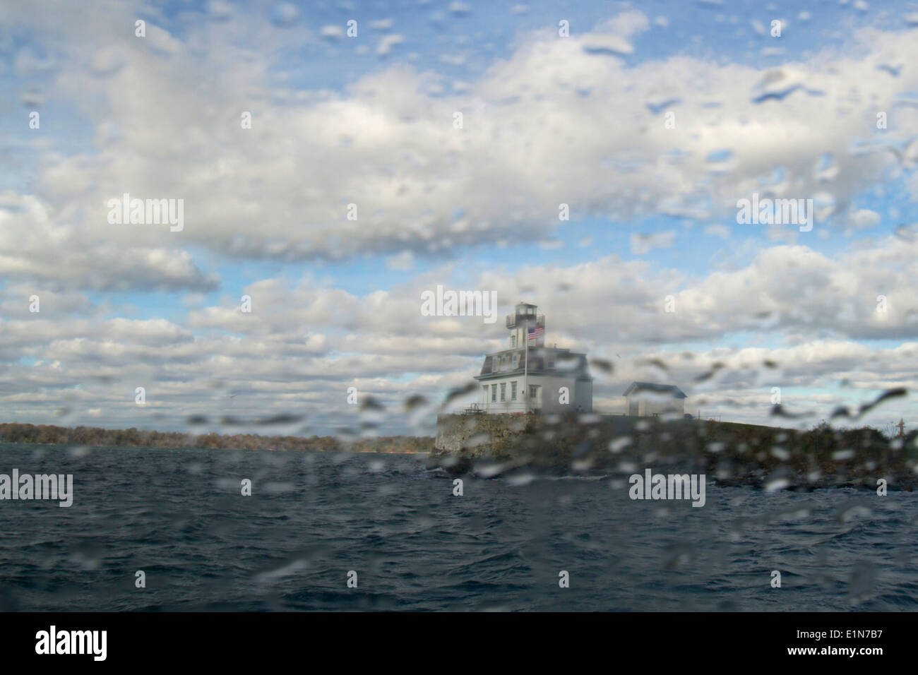 Lighthouse on remote island seen through stormy window Stock Photo - Alamy