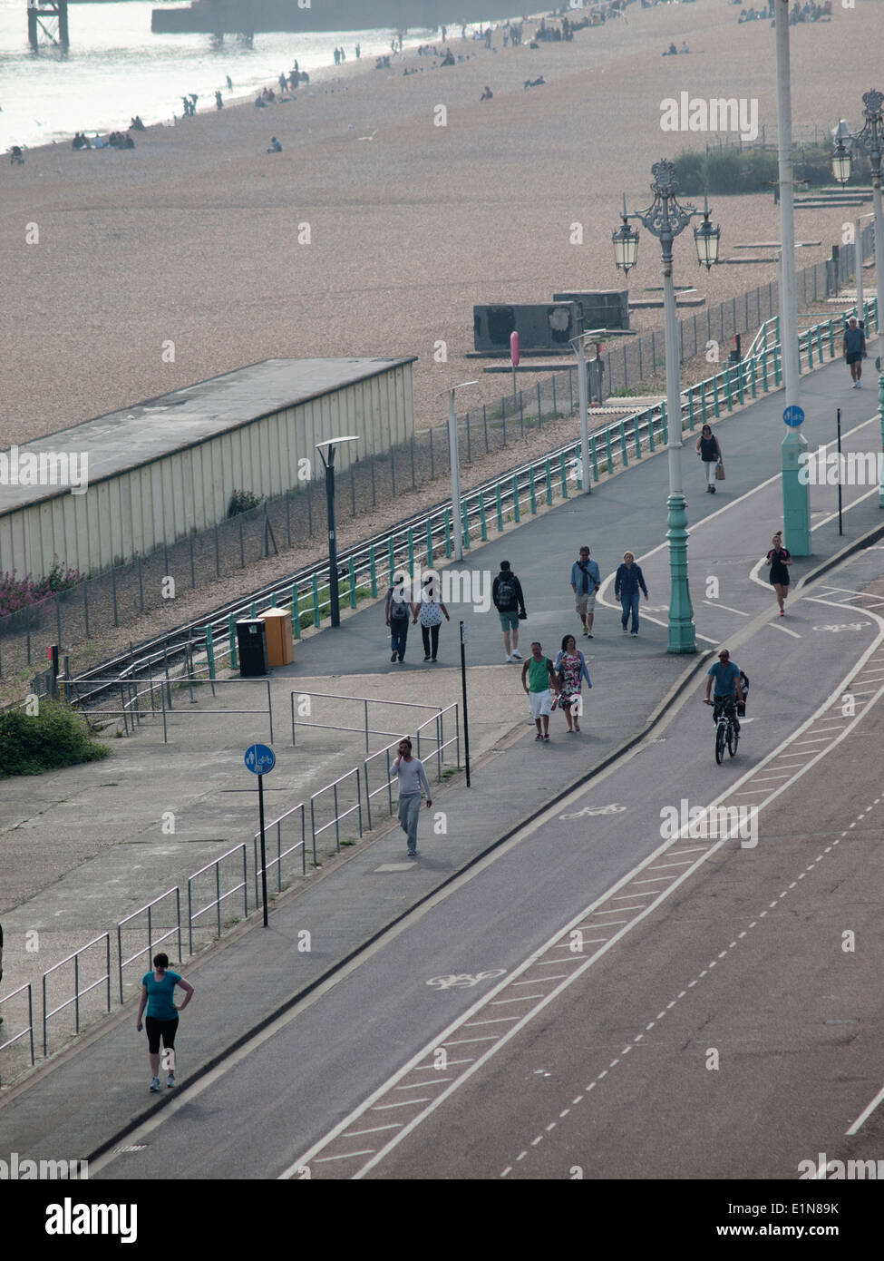 People walk along the promenade in brighton hi-res stock photography ...