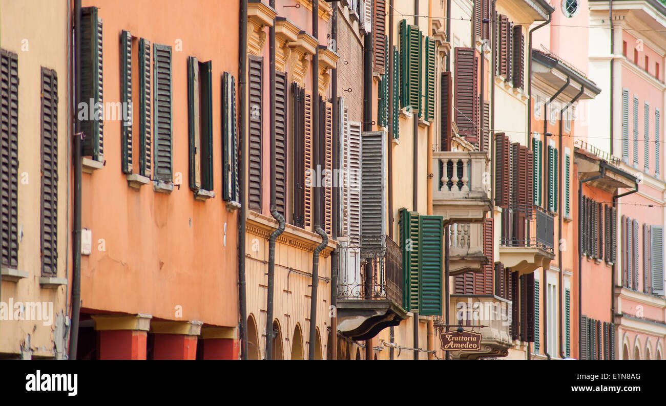 Window shutters on colourful building fronts on Bologna, Italy Stock ...