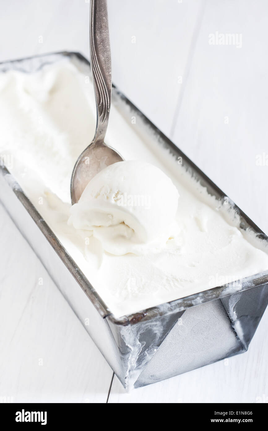 Homemade vanila ice cream in frozen metalic container. Selective focus ...