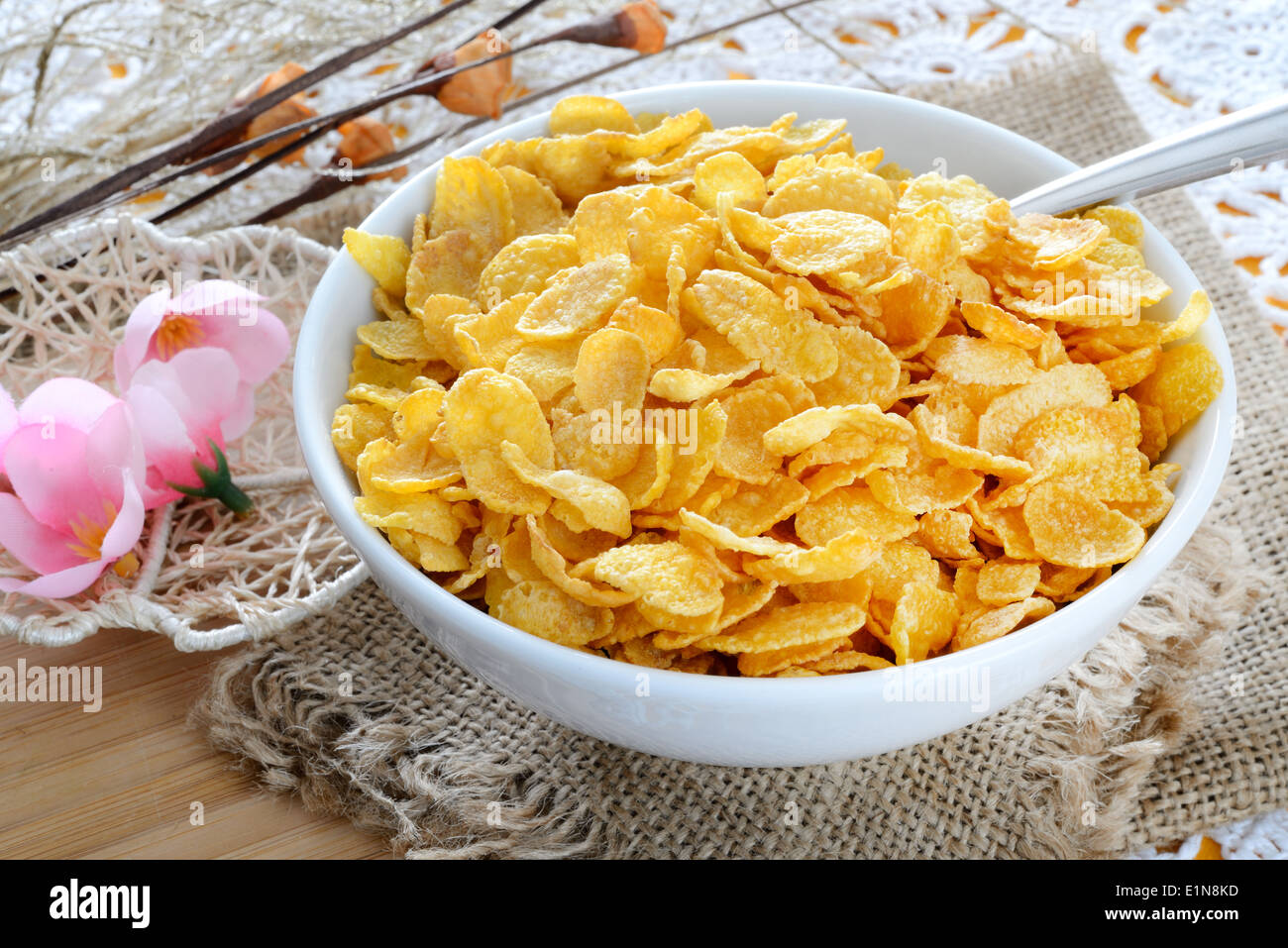 breakfast table with cornflakes cereal and pink flowers Stock Photo - Alamy