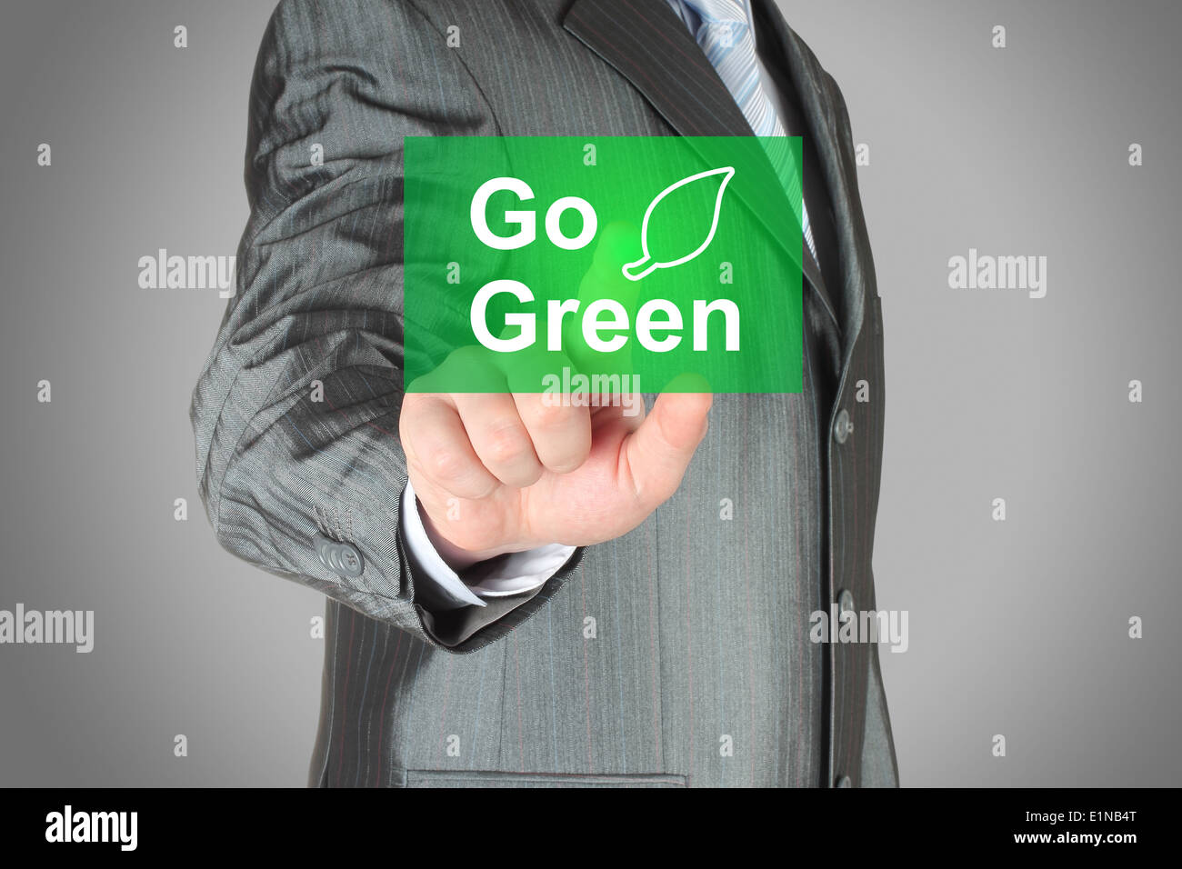 Businessman pushes touch screen go green button. Eco concept Stock ... Businessman pushes touch screen go green button. Eco concept Stock ...