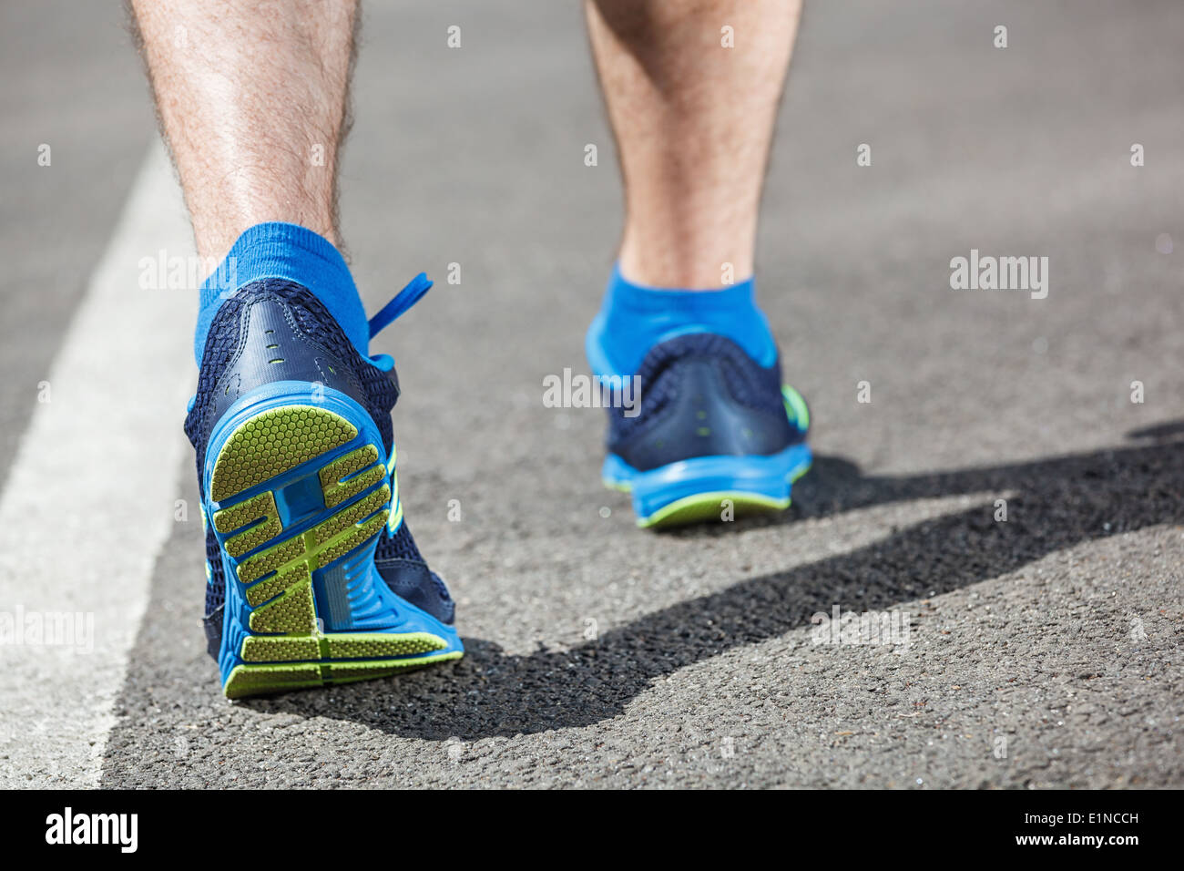 Runner feet running on stadium closeup on shoe - back view Stock Photo ...
