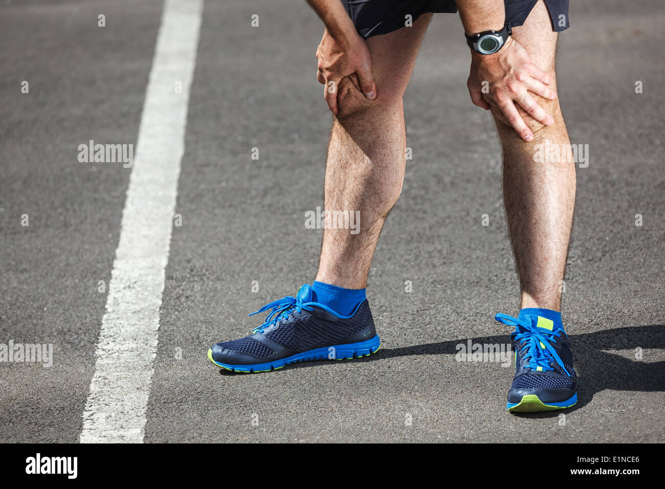 Tired male runner resting after training Stock Photo - Alamy