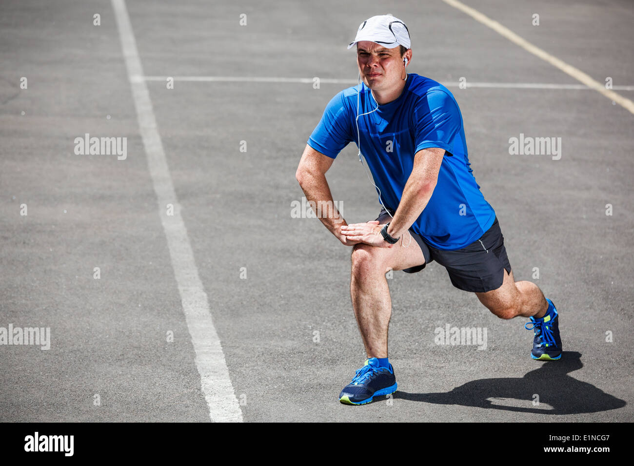 Male runner stretching before workout Stock Photo - Alamy
