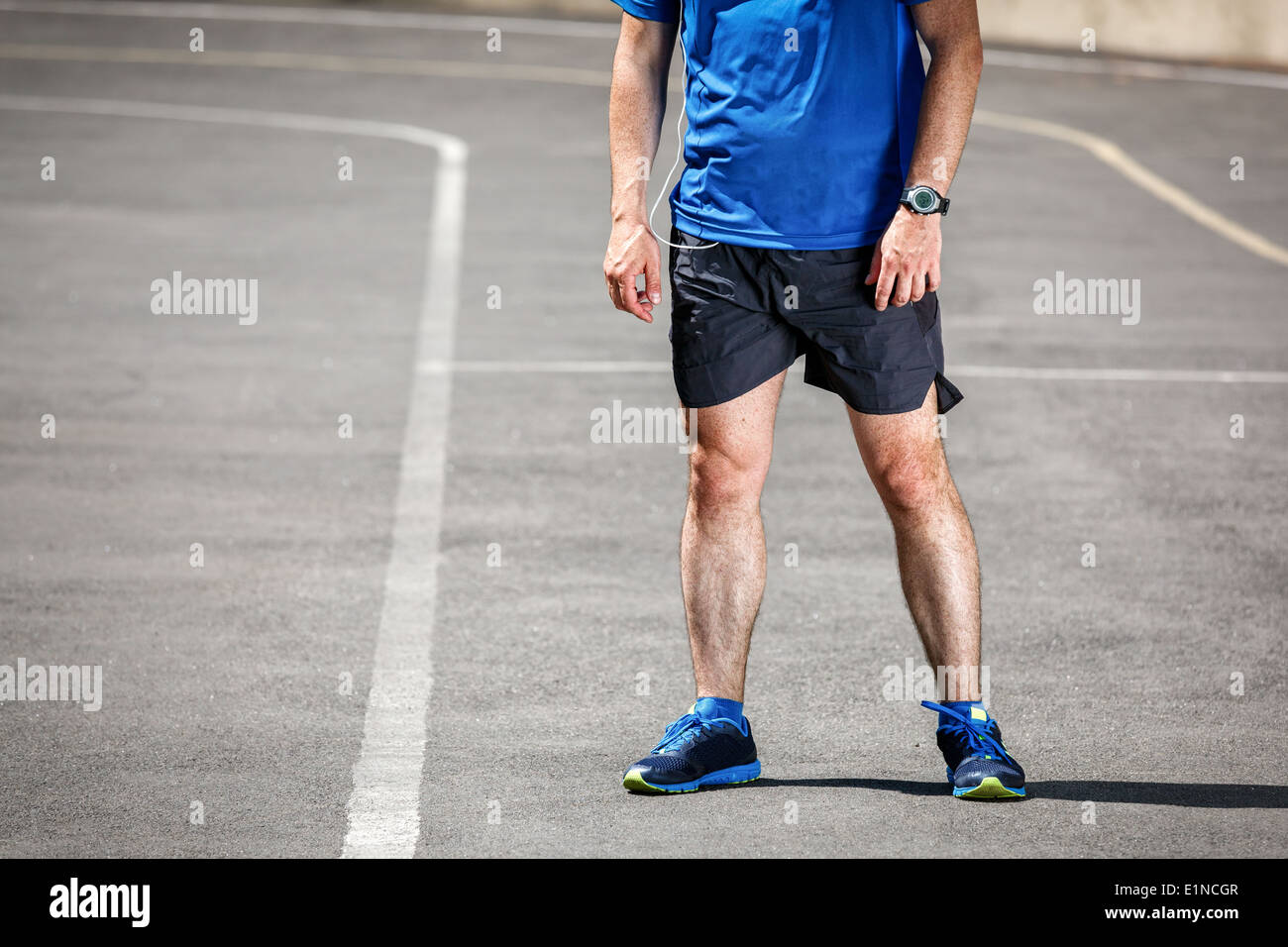 Male runner standing on racing track after workout Stock Photo - Alamy