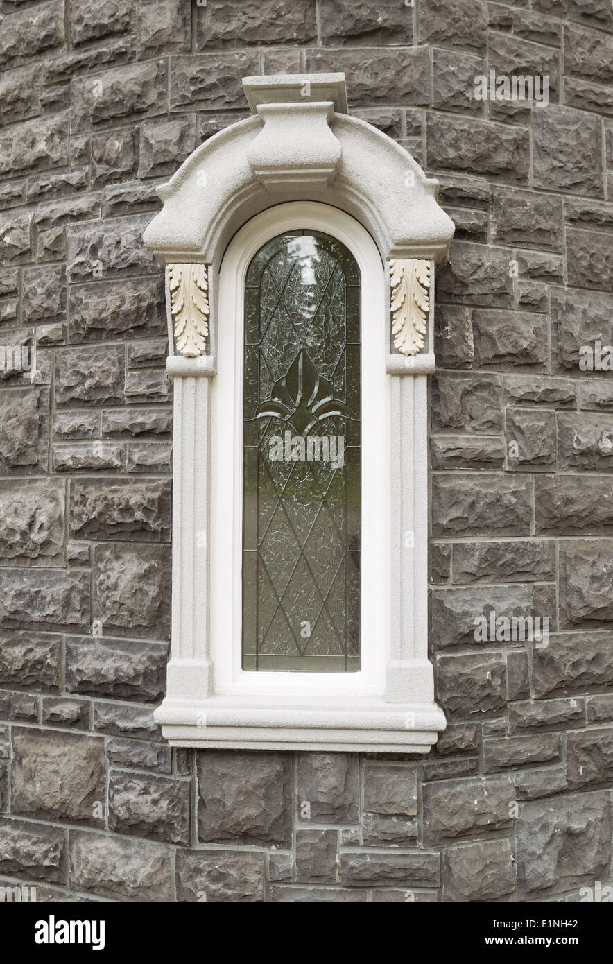 Vertical photo of brand new custom home window with stone structure in ...