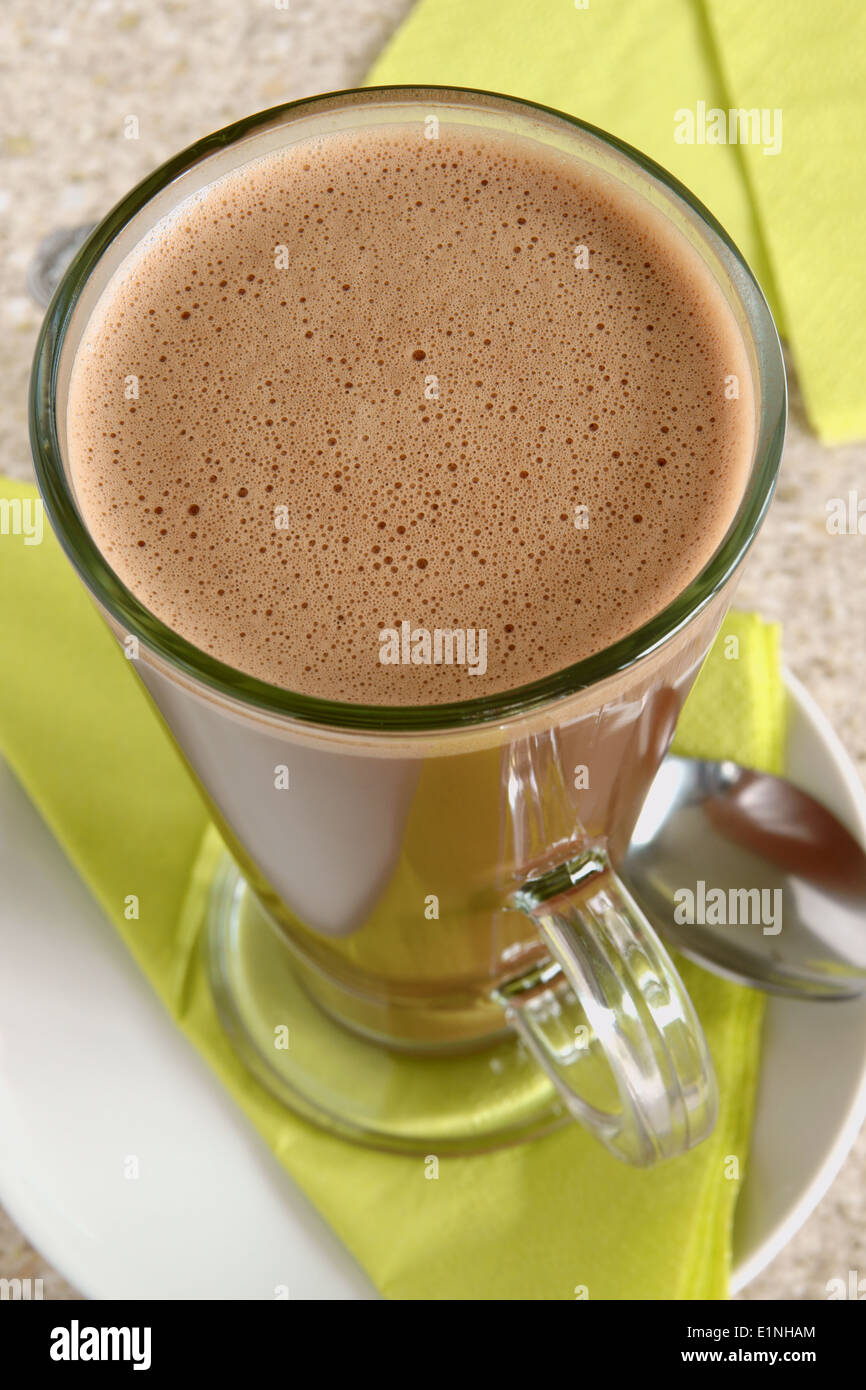 Hot chocolate in a tall latte glass top down view Stock Photo - Alamy
