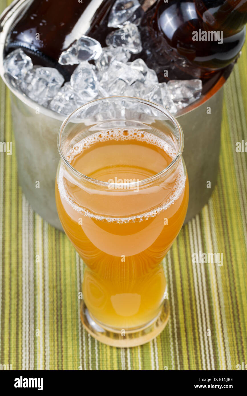 Closeup vertical photo of tall glass filled with golden color beer with ...