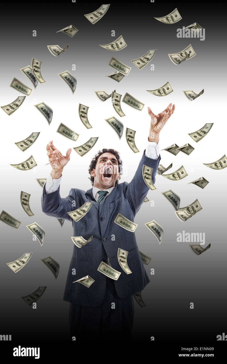 business man under falling money banknotes screaming reaching for it ...