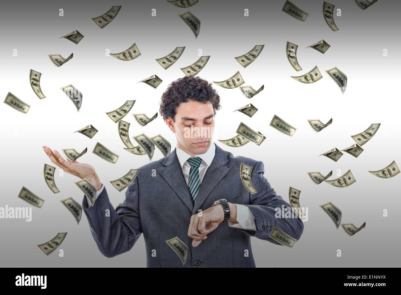 Time is money concept with man looking at watch catching falling bills ...