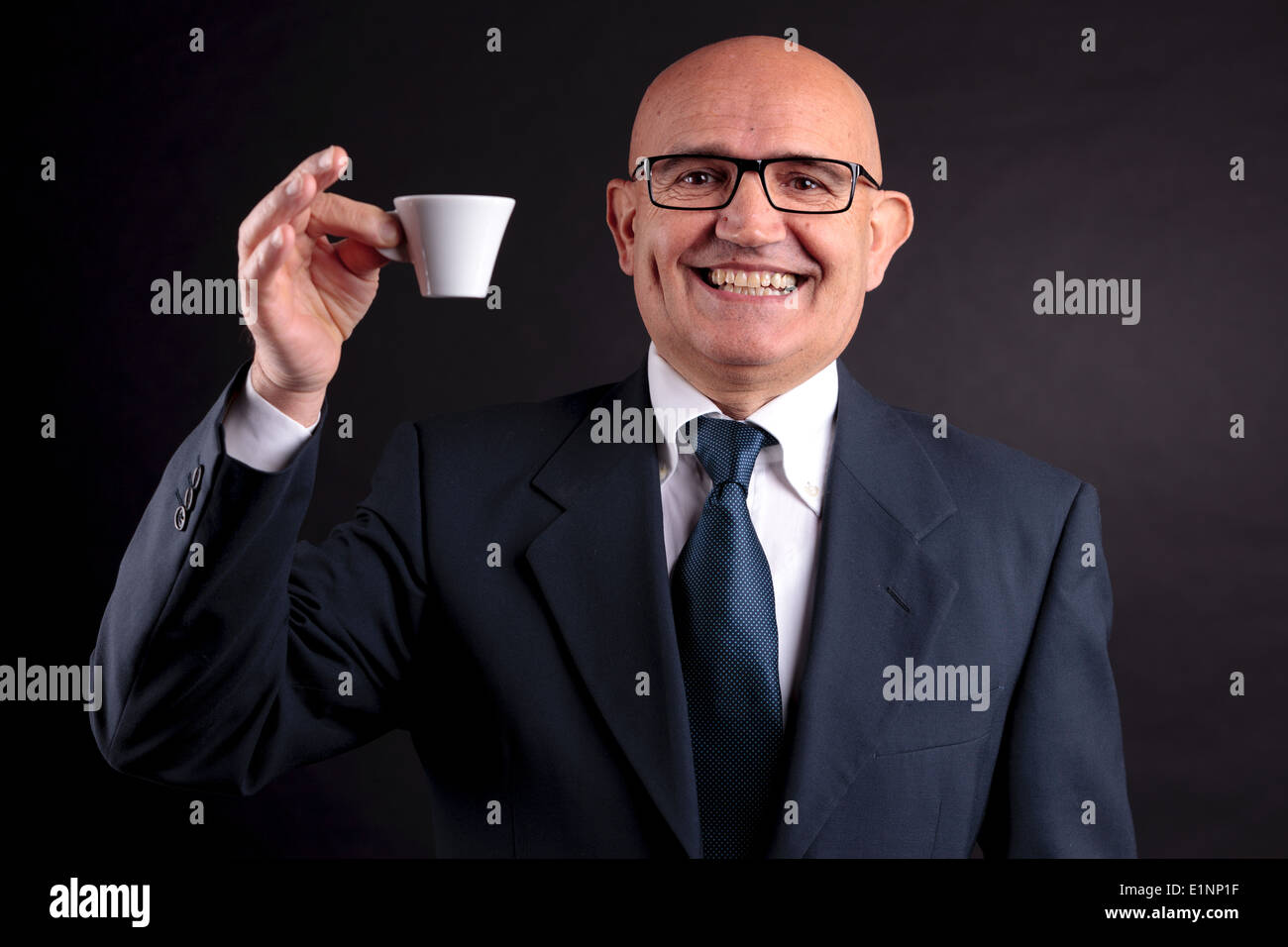 bald old smiling businessman holding a cup of espresso italian coffee ...