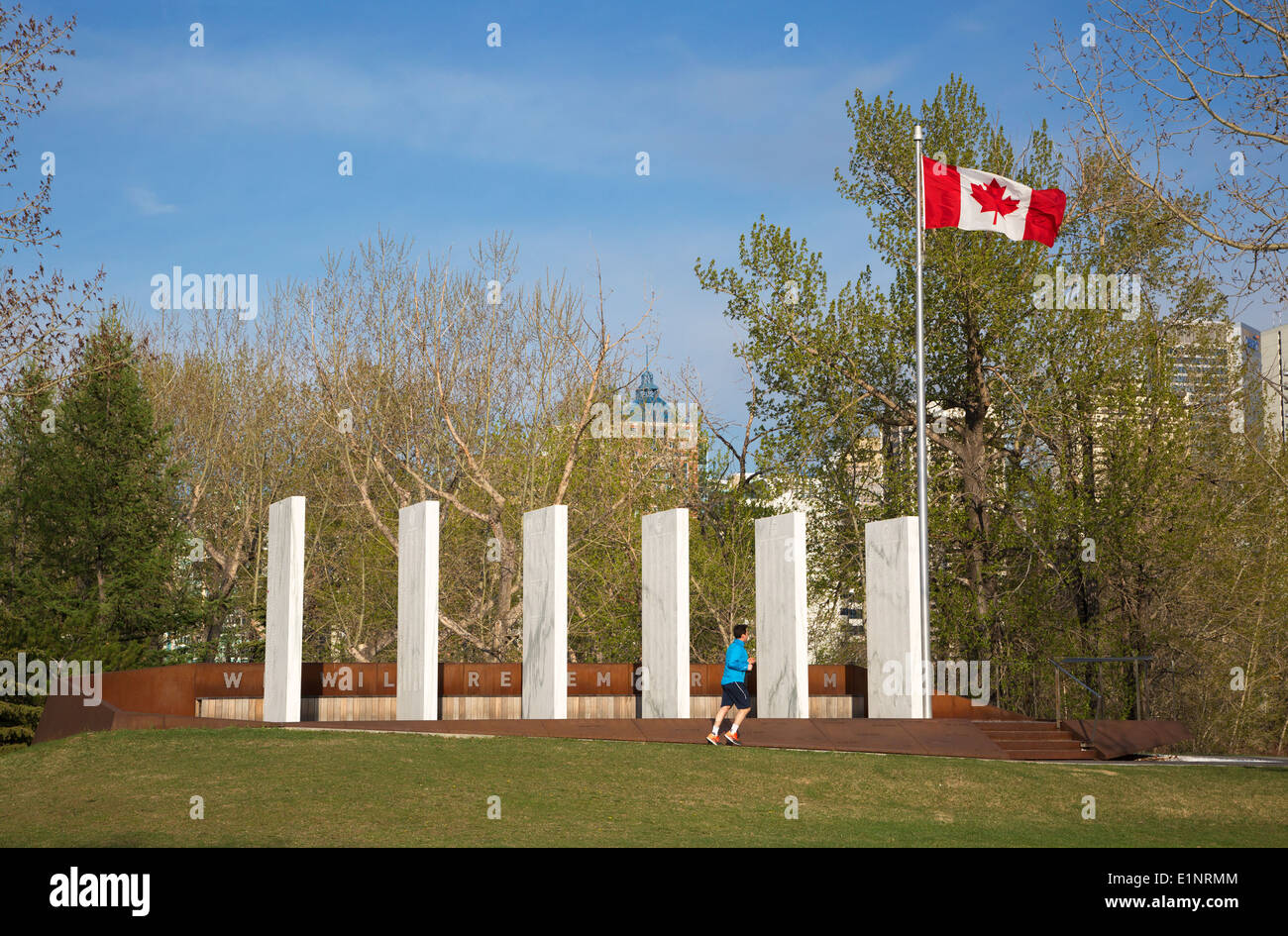 Man running past Calgary Soldiers' Memorial with Canadian flag, part of ...