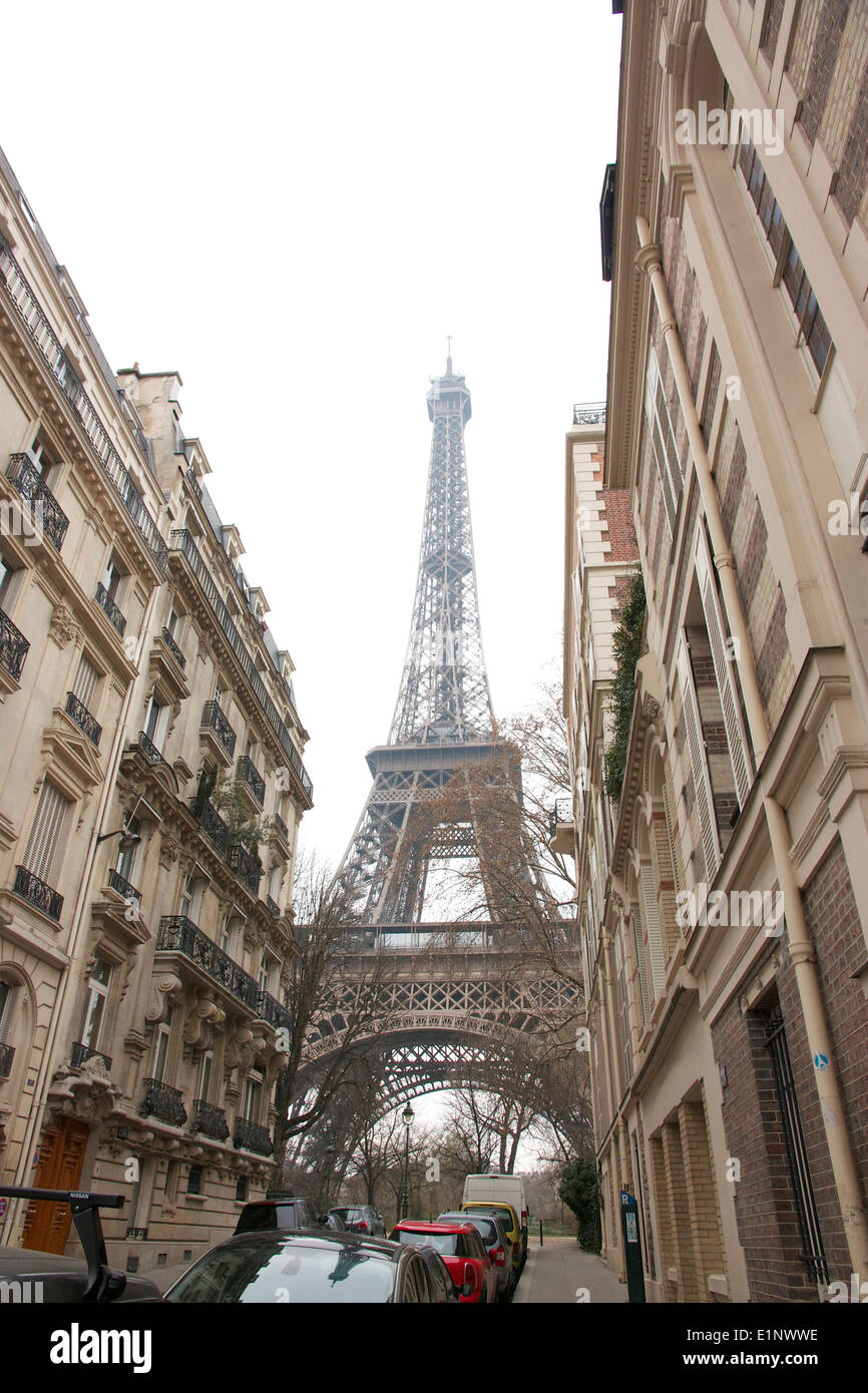 Eiffel tower between buildings Stock Photo - Alamy