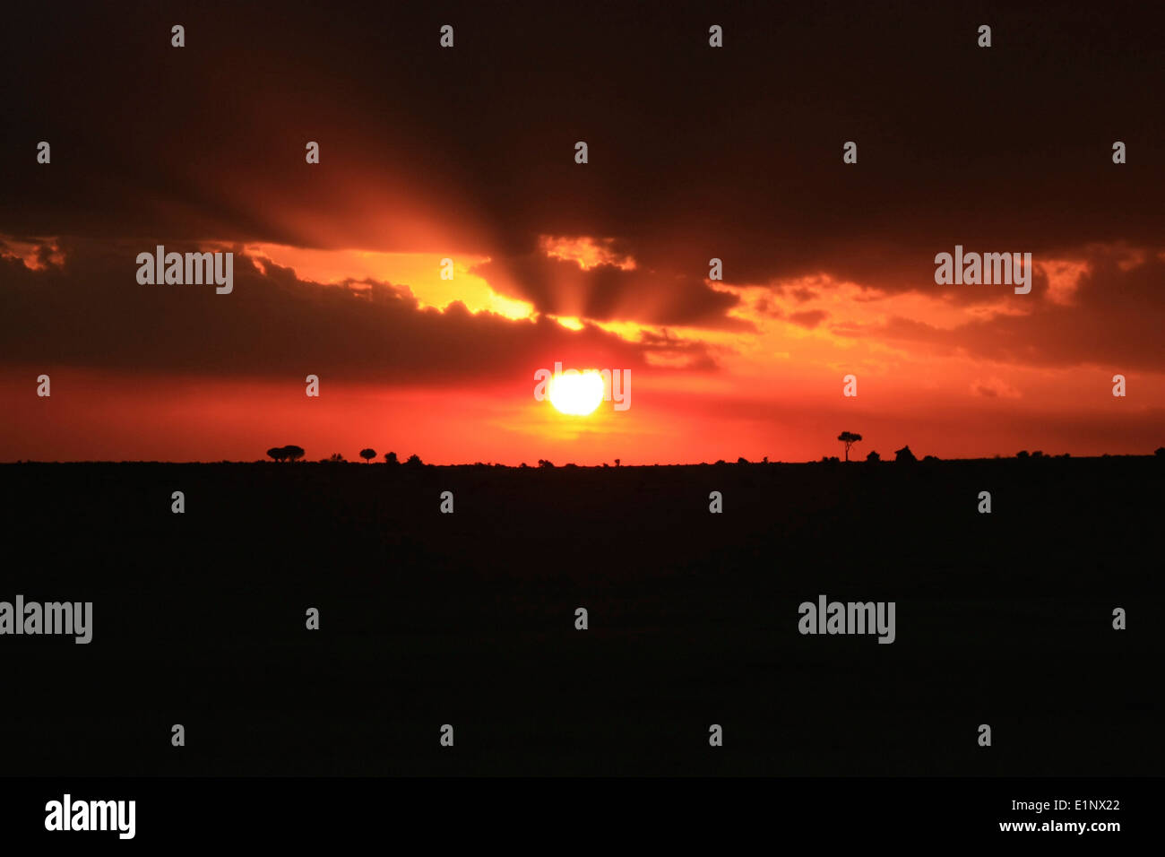 Warm Sunset in Africa between clouds Stock Photo - Alamy