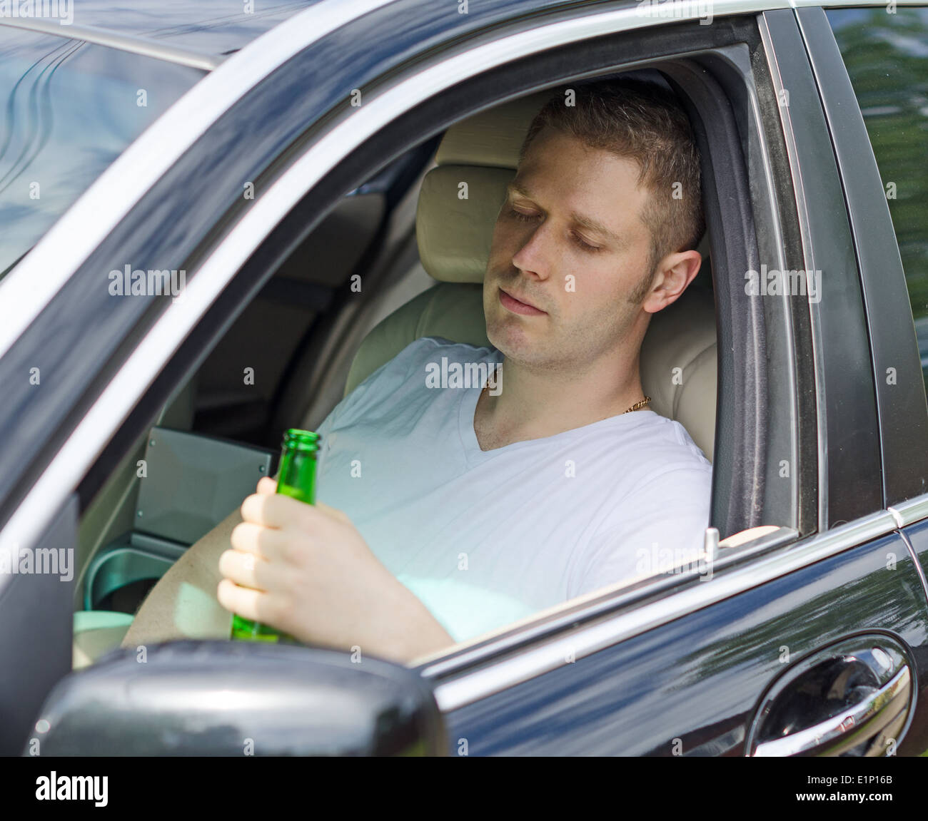 Hand holding beer bottle driving hi-res stock photography and images ...