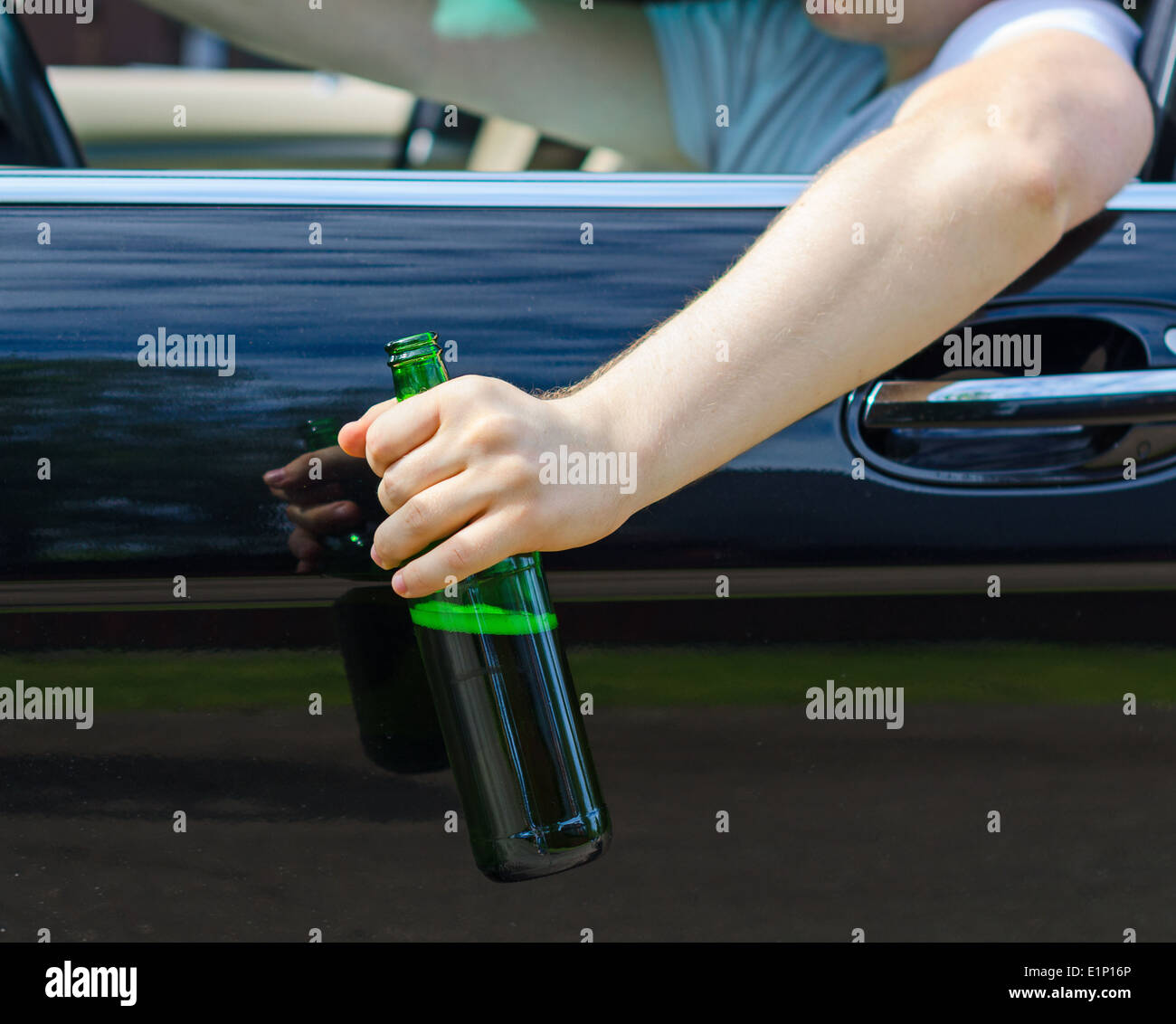 Hand holding beer bottle driving hi-res stock photography and images ...