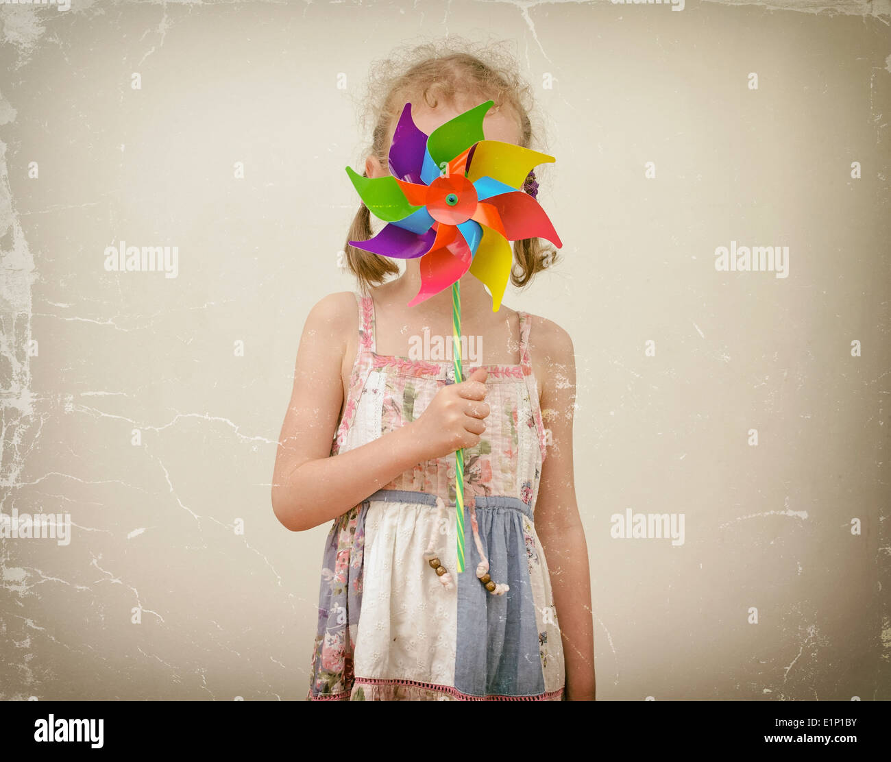 Little girl hides behind colorful pinwheel. Vintage effect Stock Photo ...