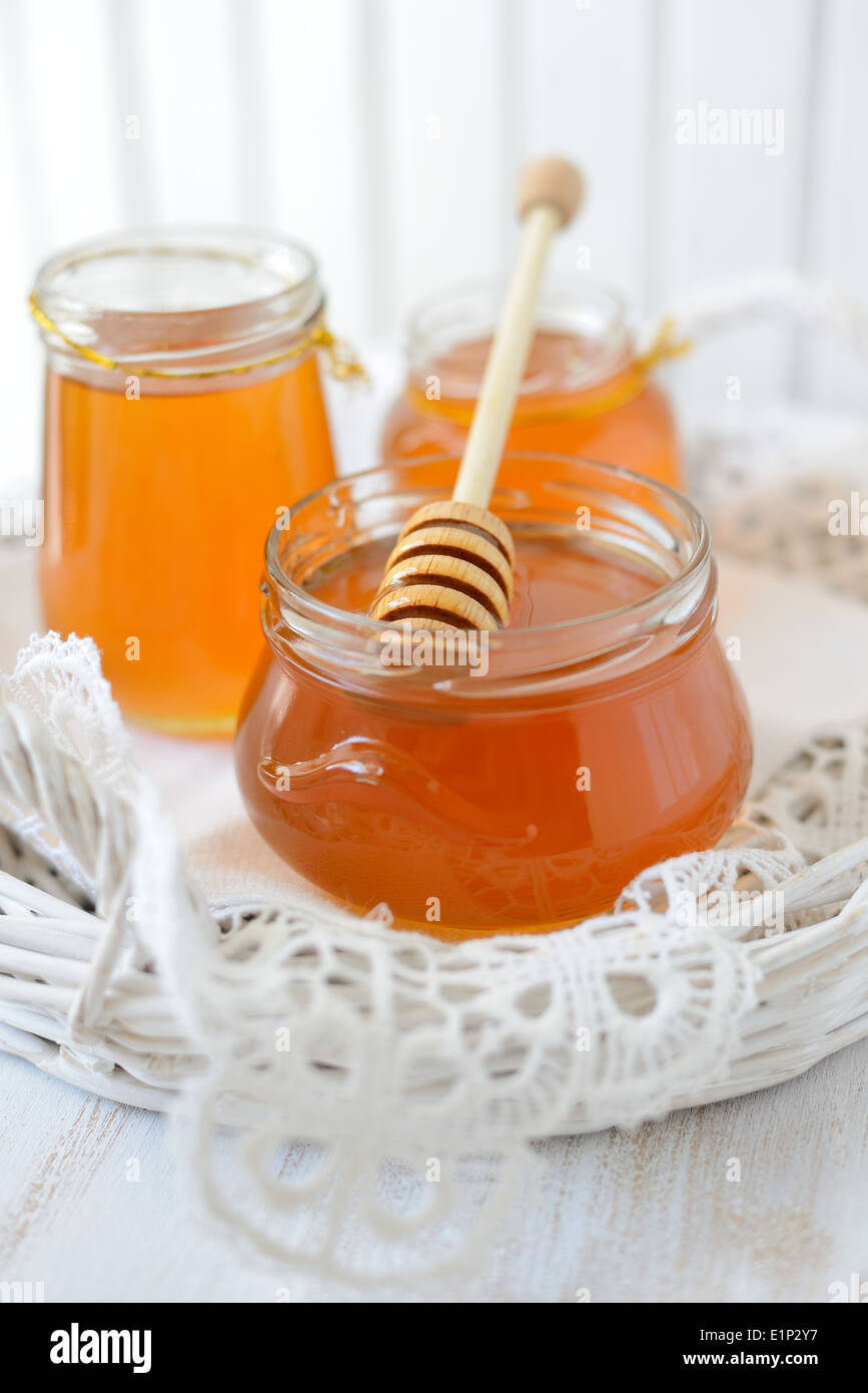 Three jars full of honey Stock Photo - Alamy