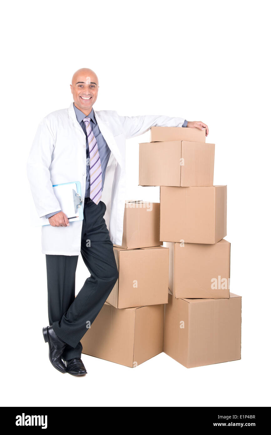 Businessman posing near a stack of cardboard boxes Stock Photo - Alamy