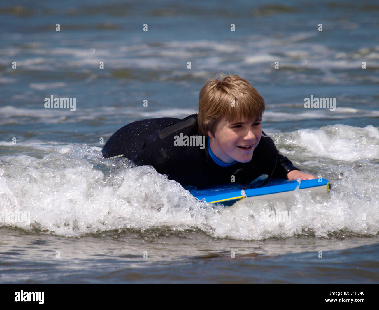 Child learning to bodyboard, Bude, Cornwall, UK Stock Photo - Alamy