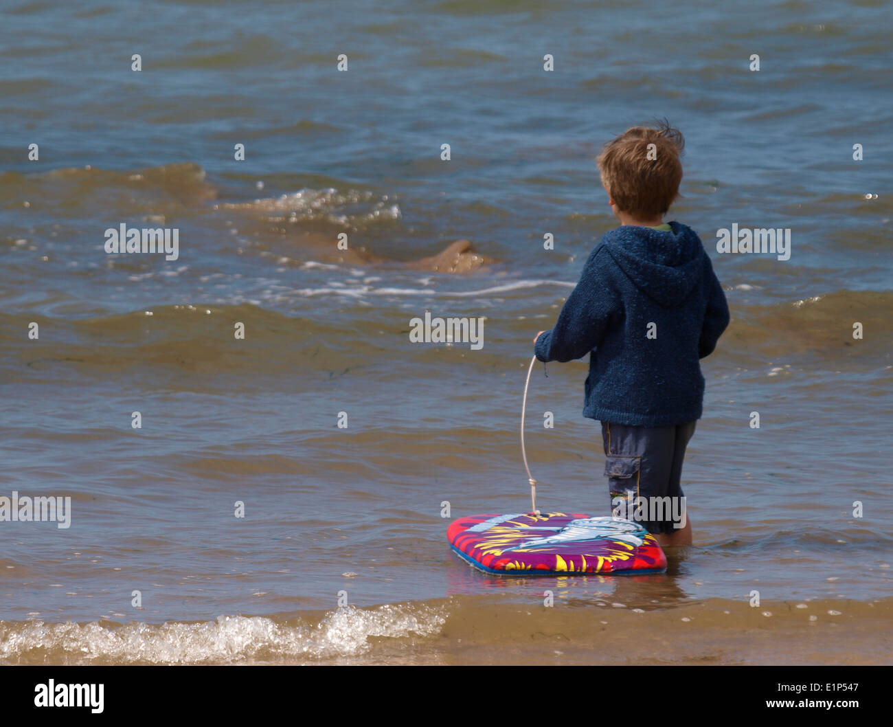 Young child paddling in the sea, Bude, Cornwall, UK Stock Photo - Alamy