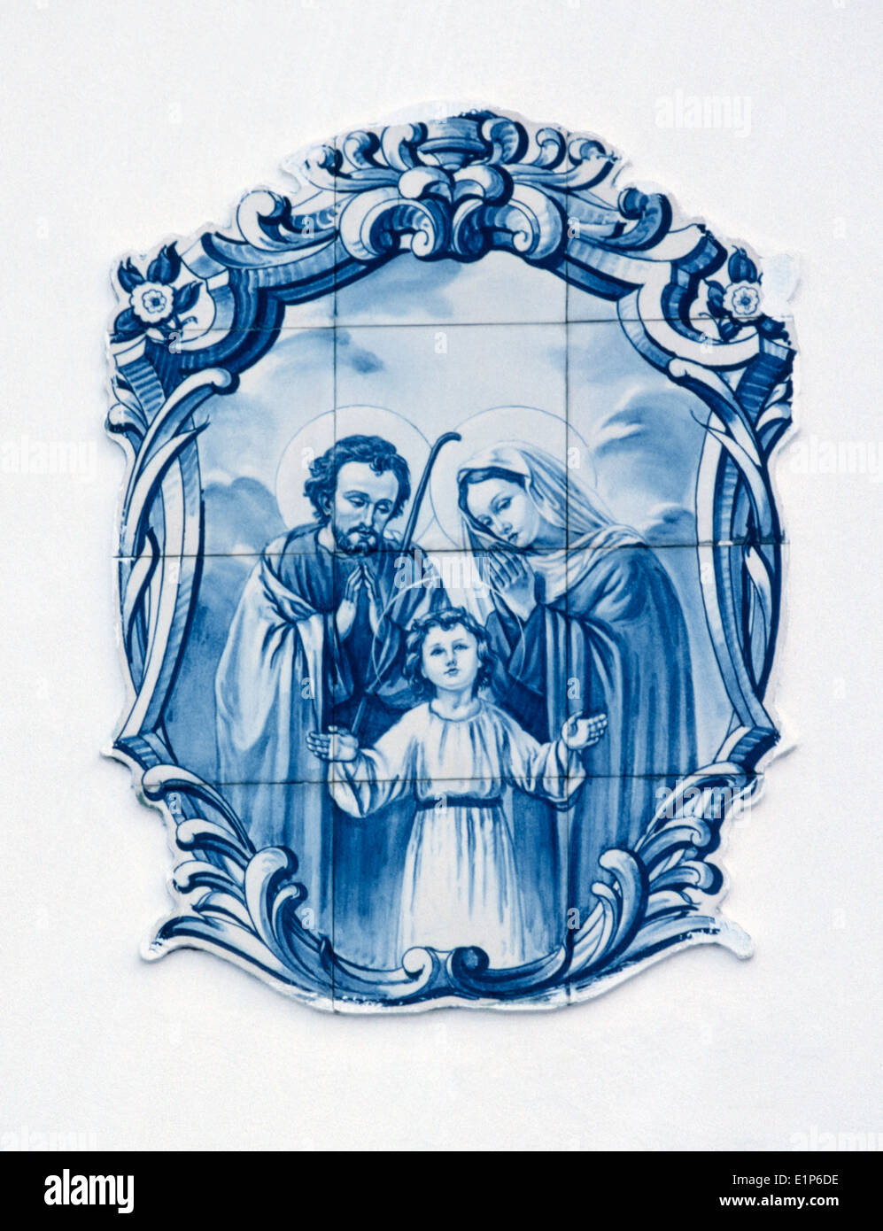 Religious tiles depicting Jesus, Joseph and Mary decorate a wall in ...