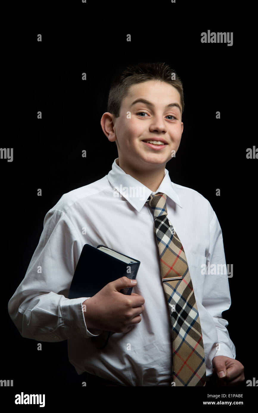 A young boy carrying scriptures on his way to church Stock Photo - Alamy