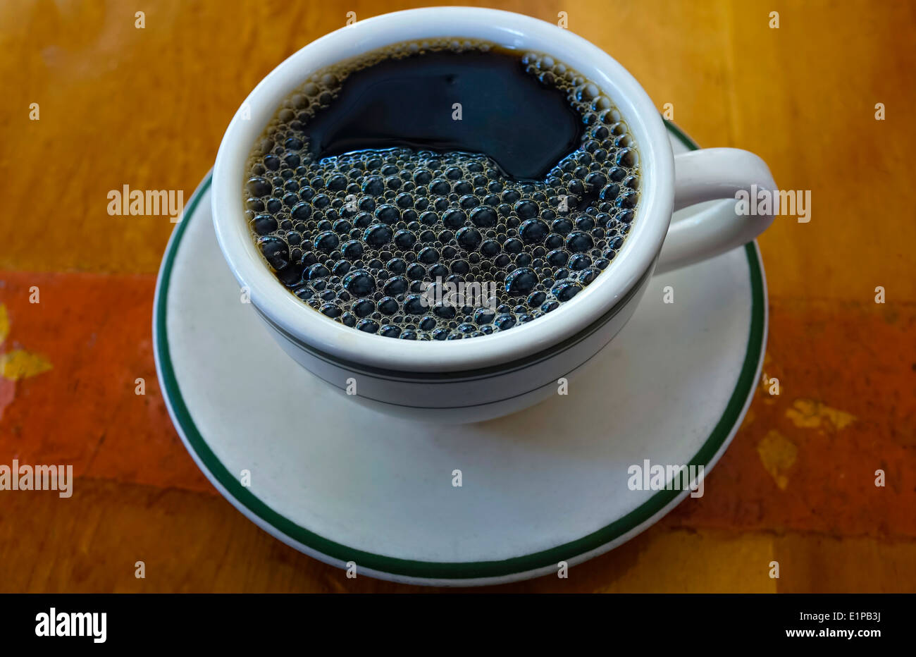 Cup of black coffee showing bubbles Stock Photo - Alamy