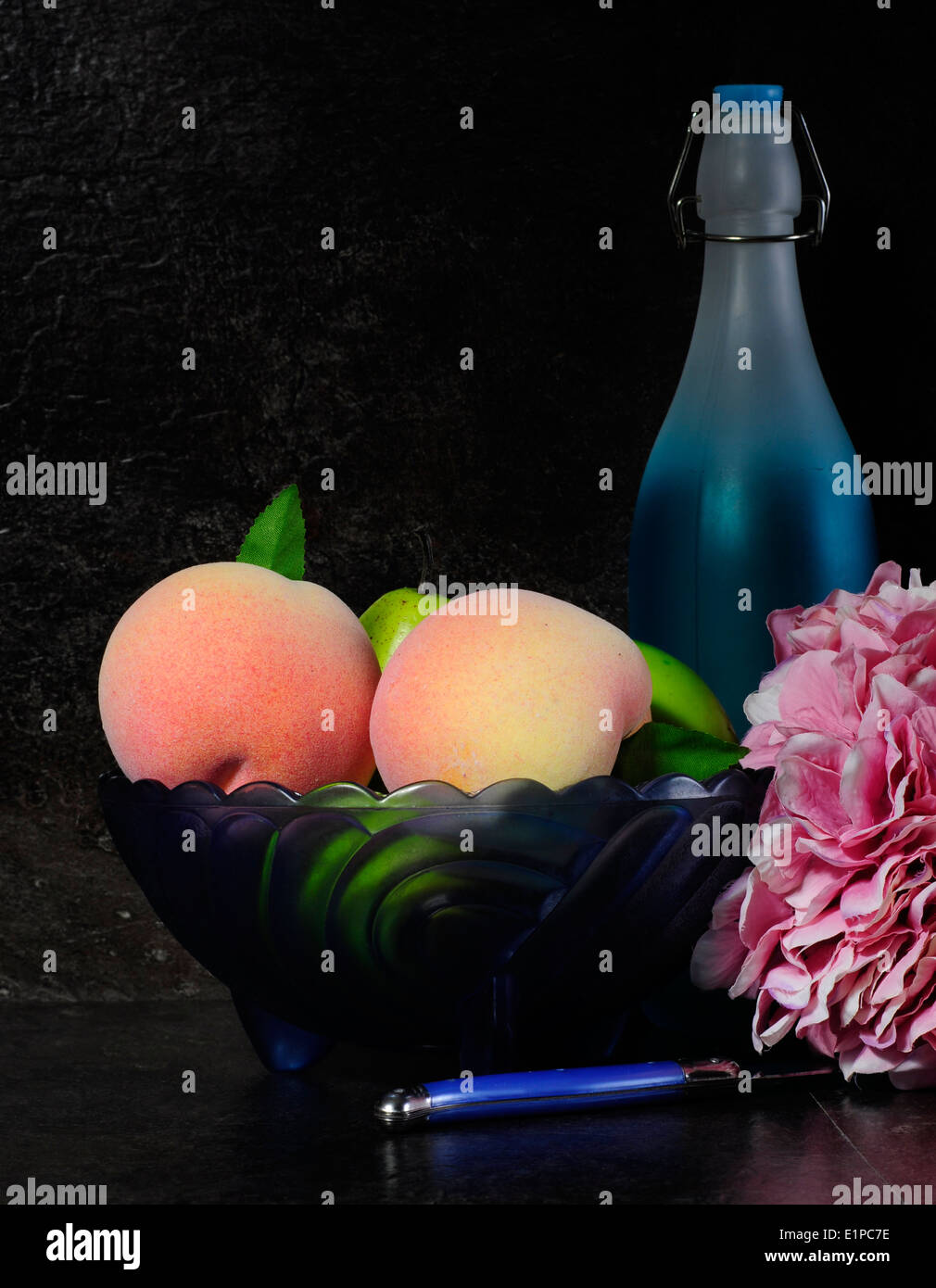 Dramatic style kitchen still life with peaches in vintage blue glass ...