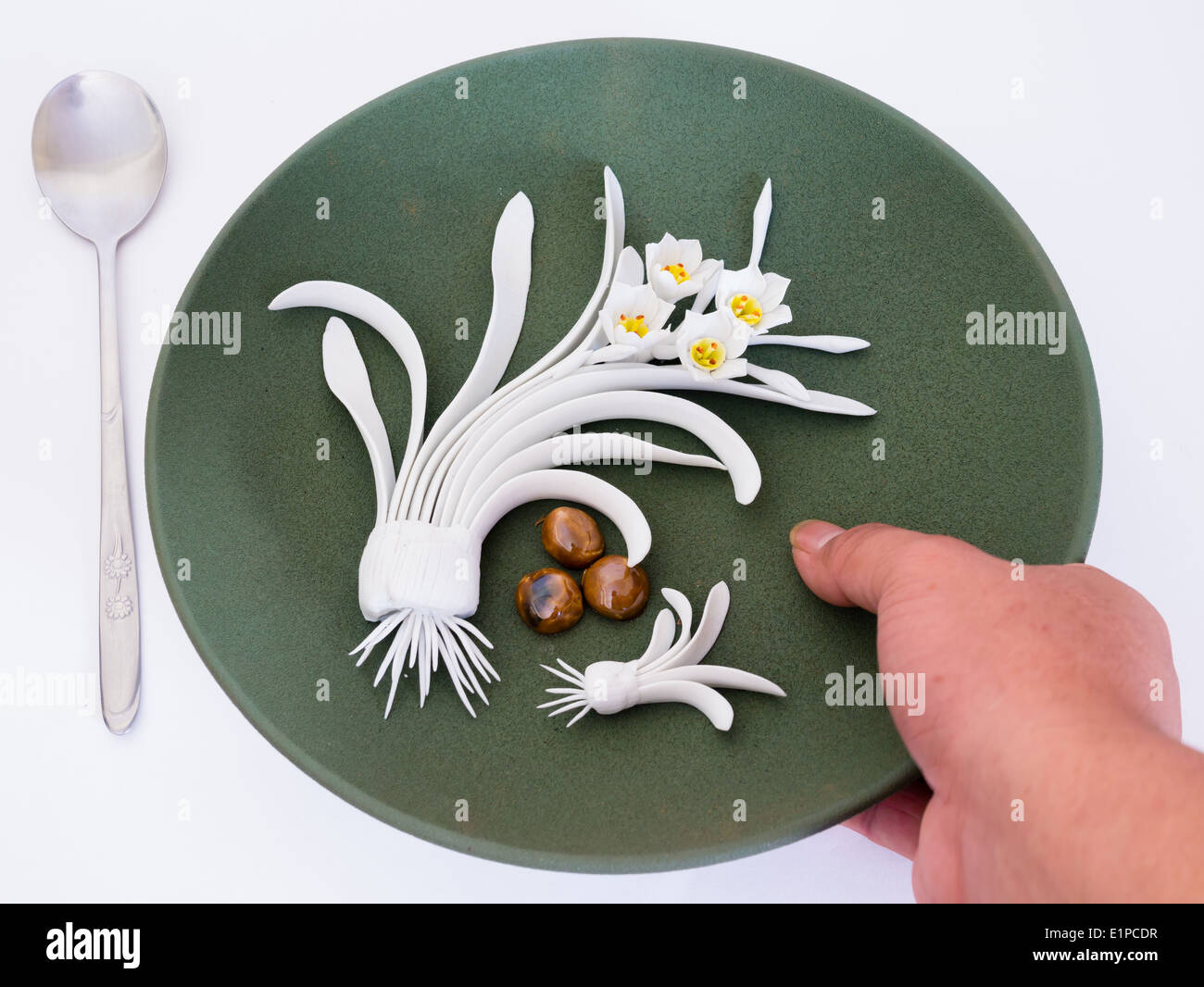 Dish decorated with flowers, which are handmade. Art is beautiful ...