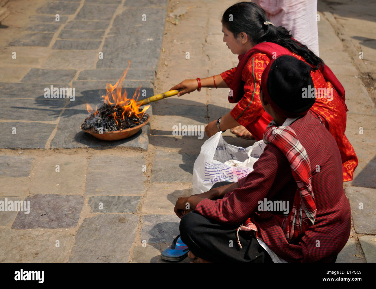 two women making offering of fire Stock Photo - Alamy