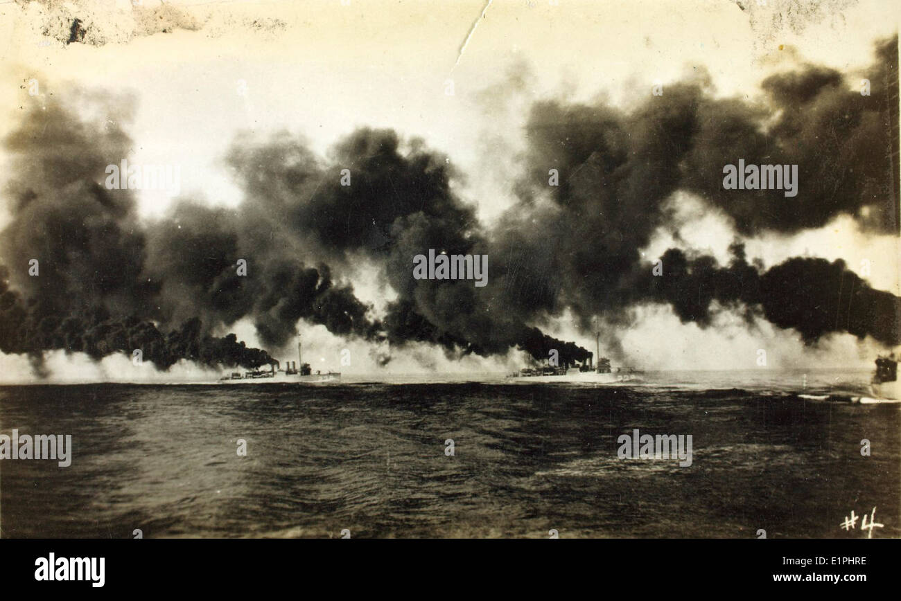 This photograph depicts a World War I naval ship using a smokescreen, a ...