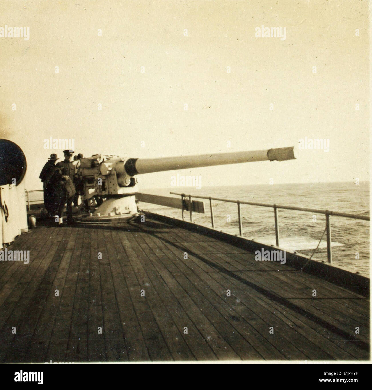 This image features a World War I naval vessel equipped with a deck gun ...