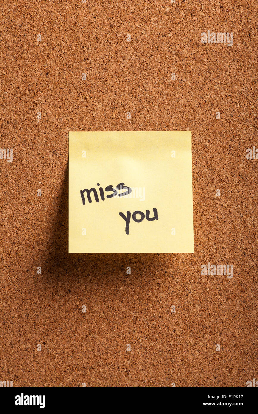 Color shot of a cork board with a sticky note reading "miss you Stock ...