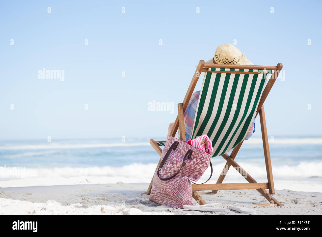 Woman sitting in chair on beach hi-res stock photography and images - Alamy