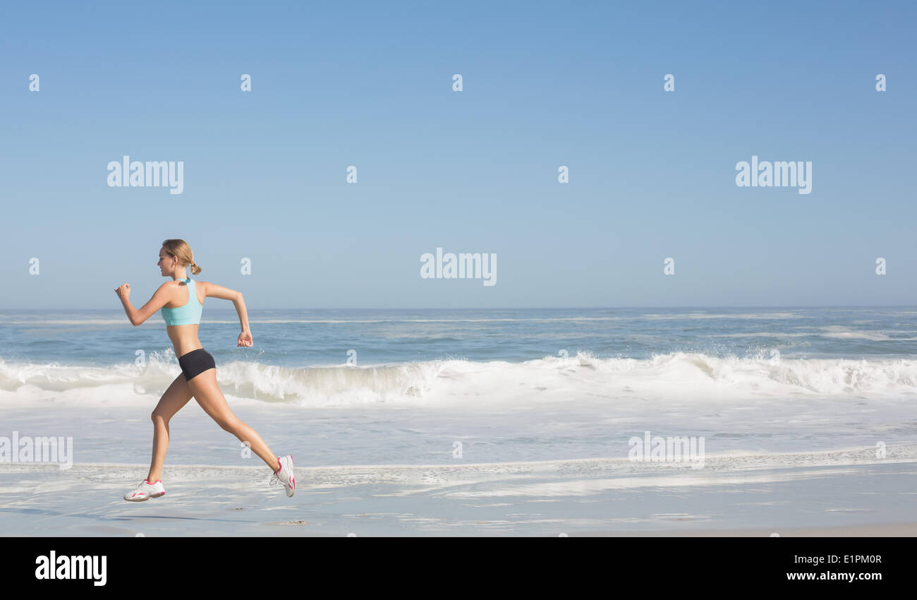 Fit woman jogging on the beach Stock Photo - Alamy