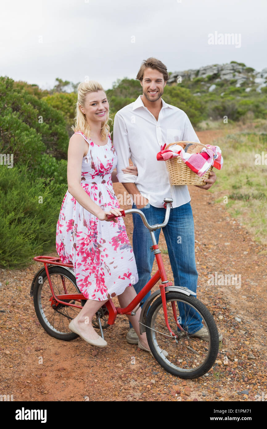 Cute couple going for a picnic smiling at camera Stock Photo - Alamy