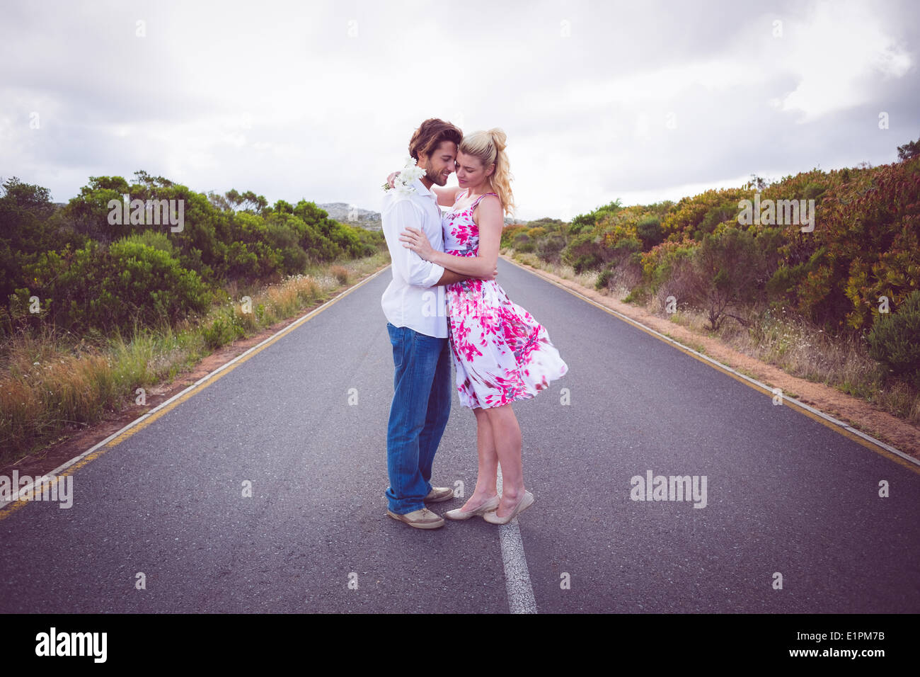 Cute couple standing on the road hugging Stock Photo - Alamy