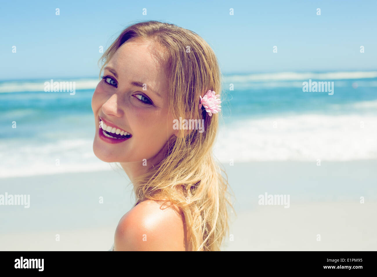 Beautiful blonde smiling at camera on the beach Stock Photo - Alamy