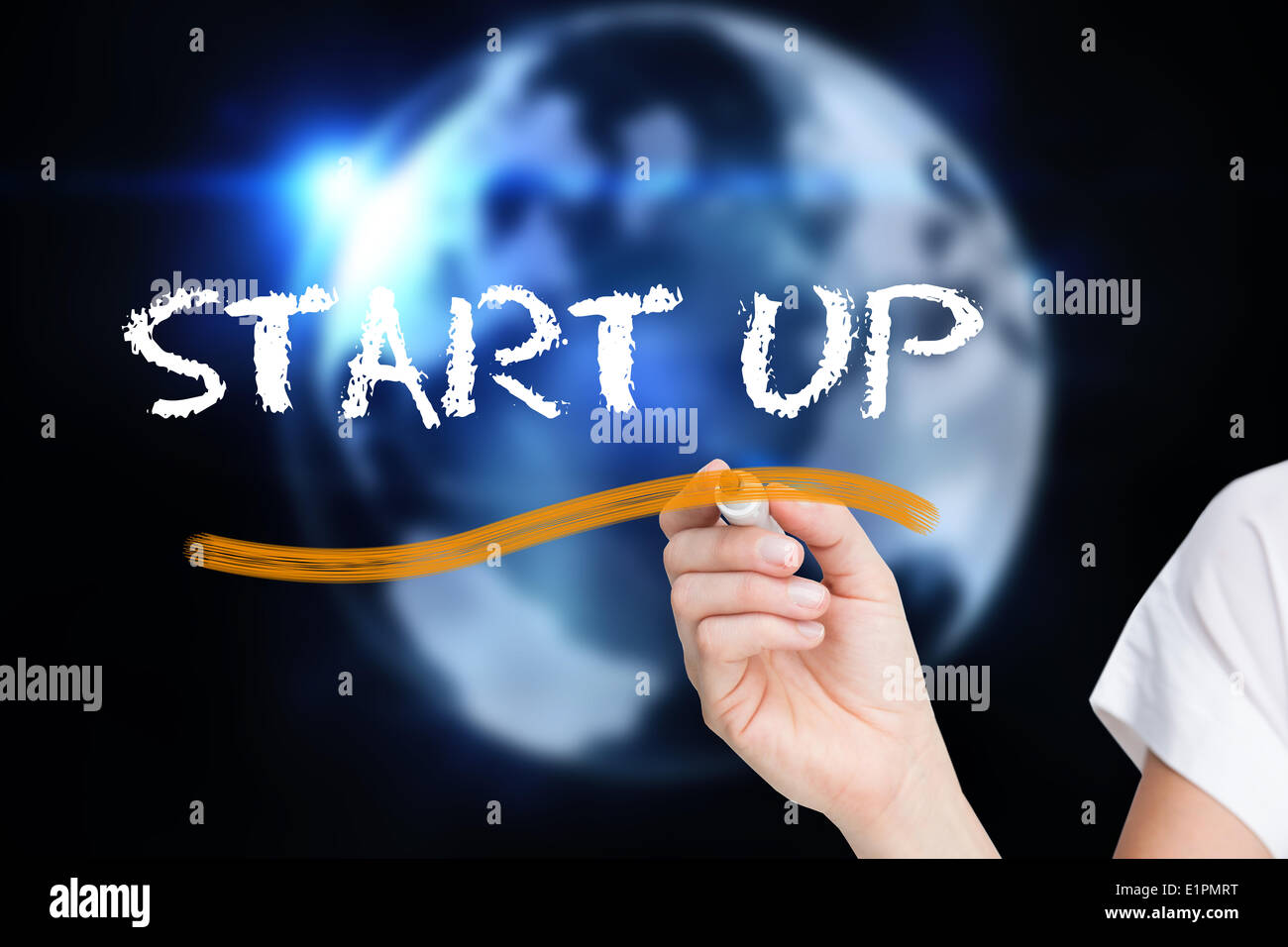 Businesswoman writing the word start up Stock Photo - Alamy