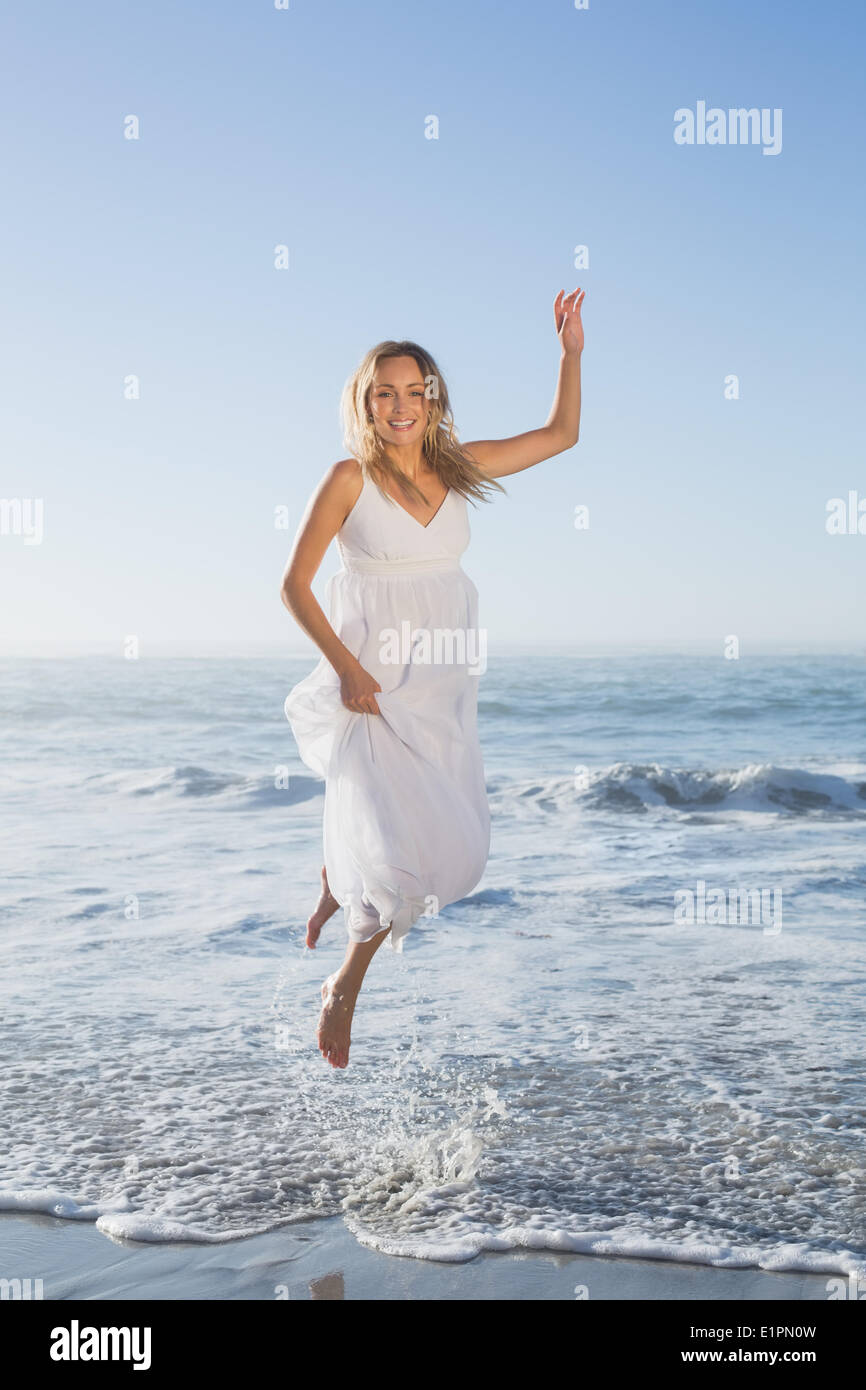 Portrait of woman jumping at beach hi-res stock photography and images ...
