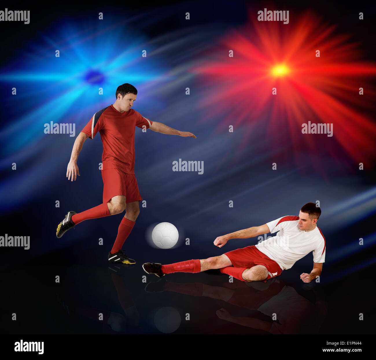 Football players tackling for the ball Stock Photo - Alamy